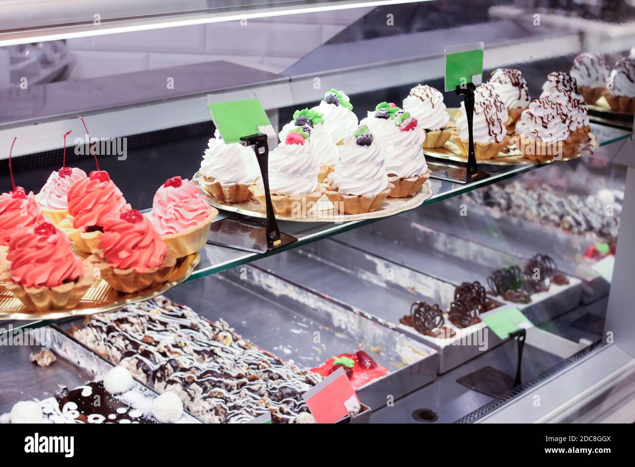 Bright cakes on a shop window close up Stock Photo - Alamy