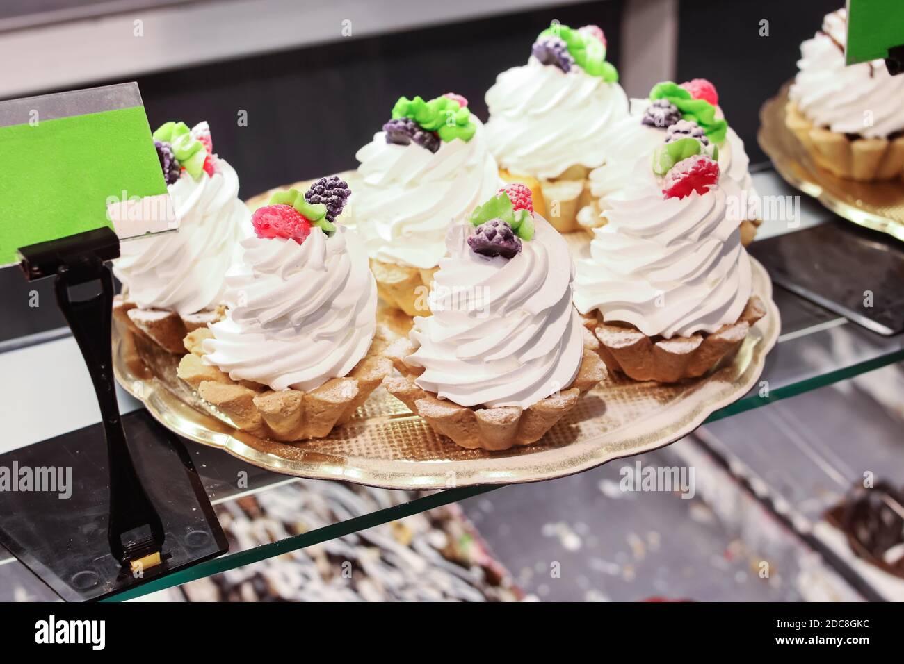 Bright cakes on a shop window close up Stock Photo - Alamy