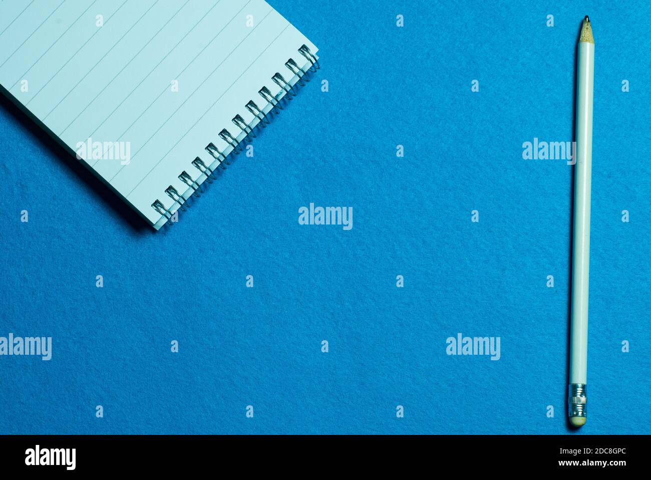 blank page of notebook on light blue background Stock Photo - Alamy