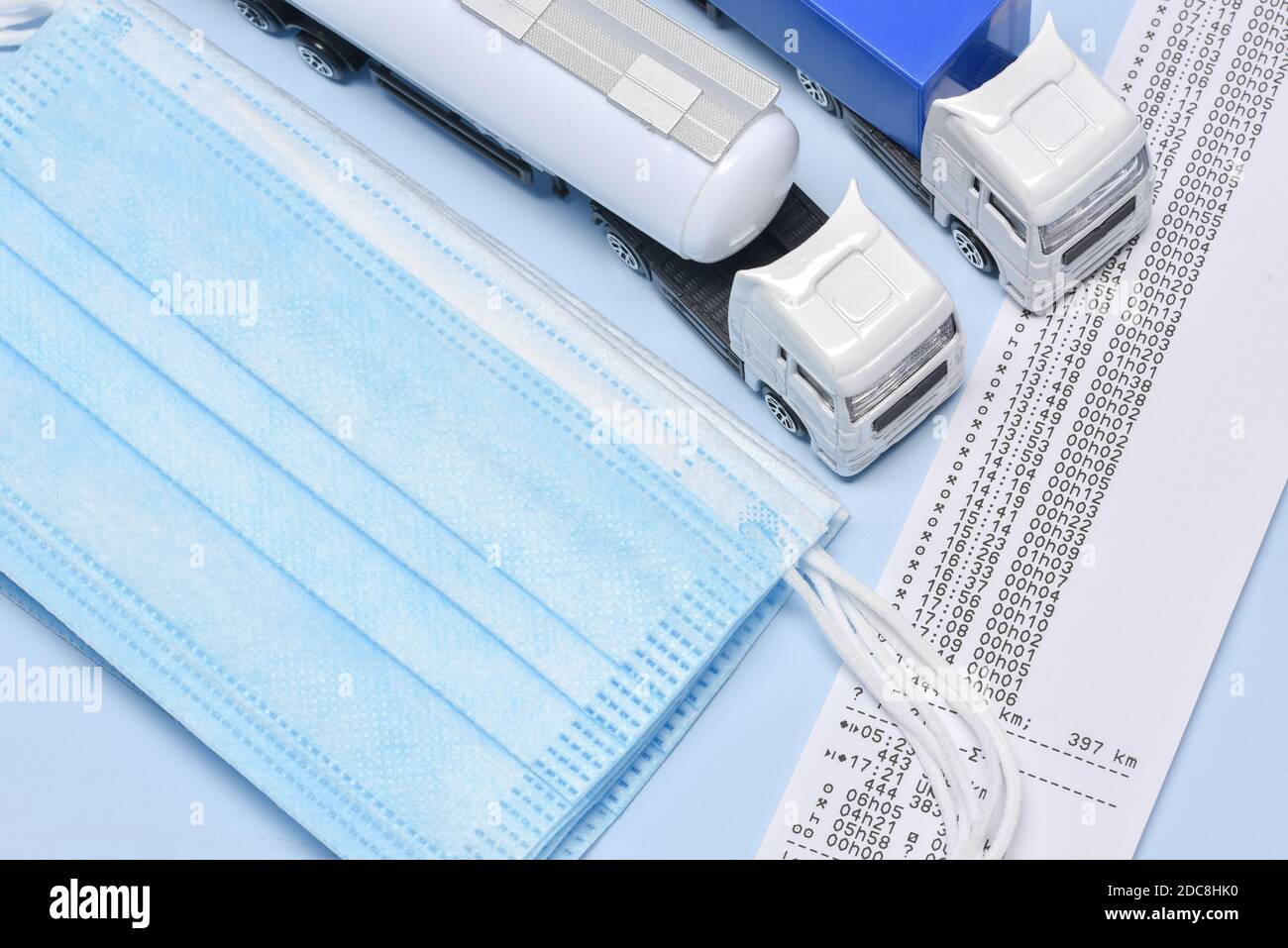 Two lorry toys, and face mask in concept about transport departament ...