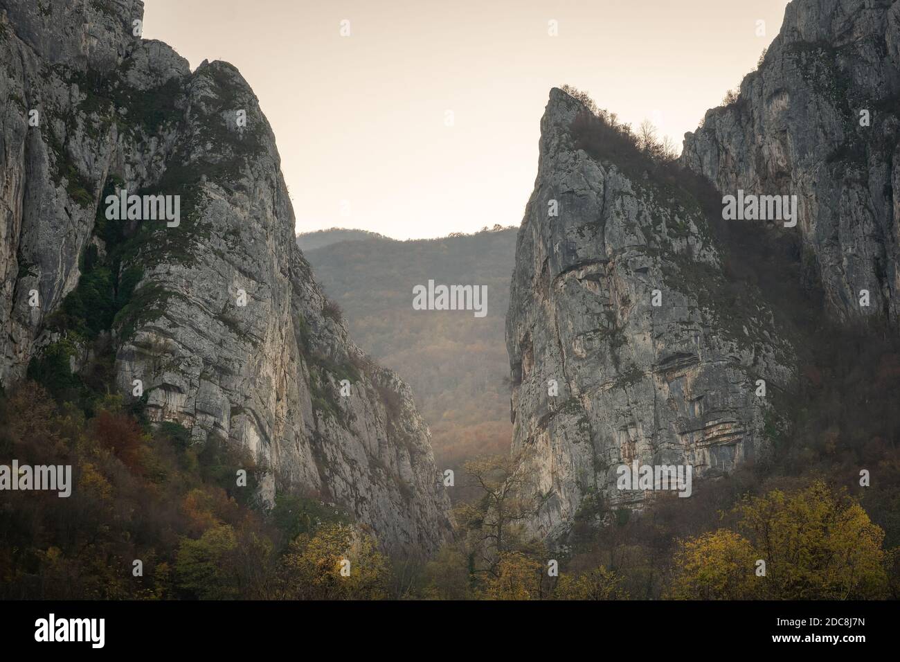 Close up of impressive pointy mountain cliffs at the misty entrance of ...