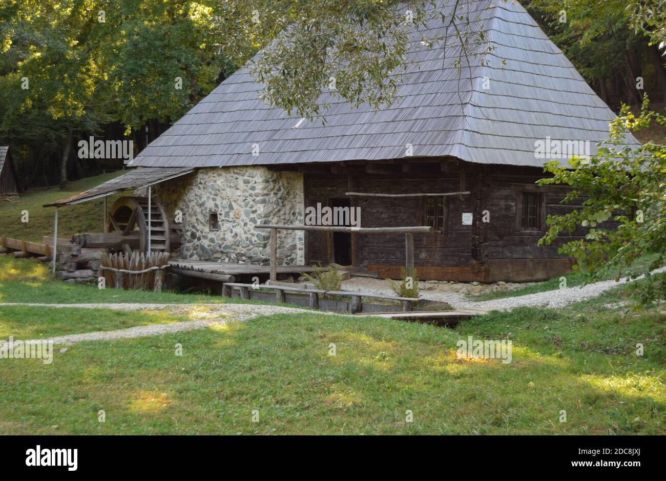 Old water mill made of stone and wood. Shingled building Stock Photo ...