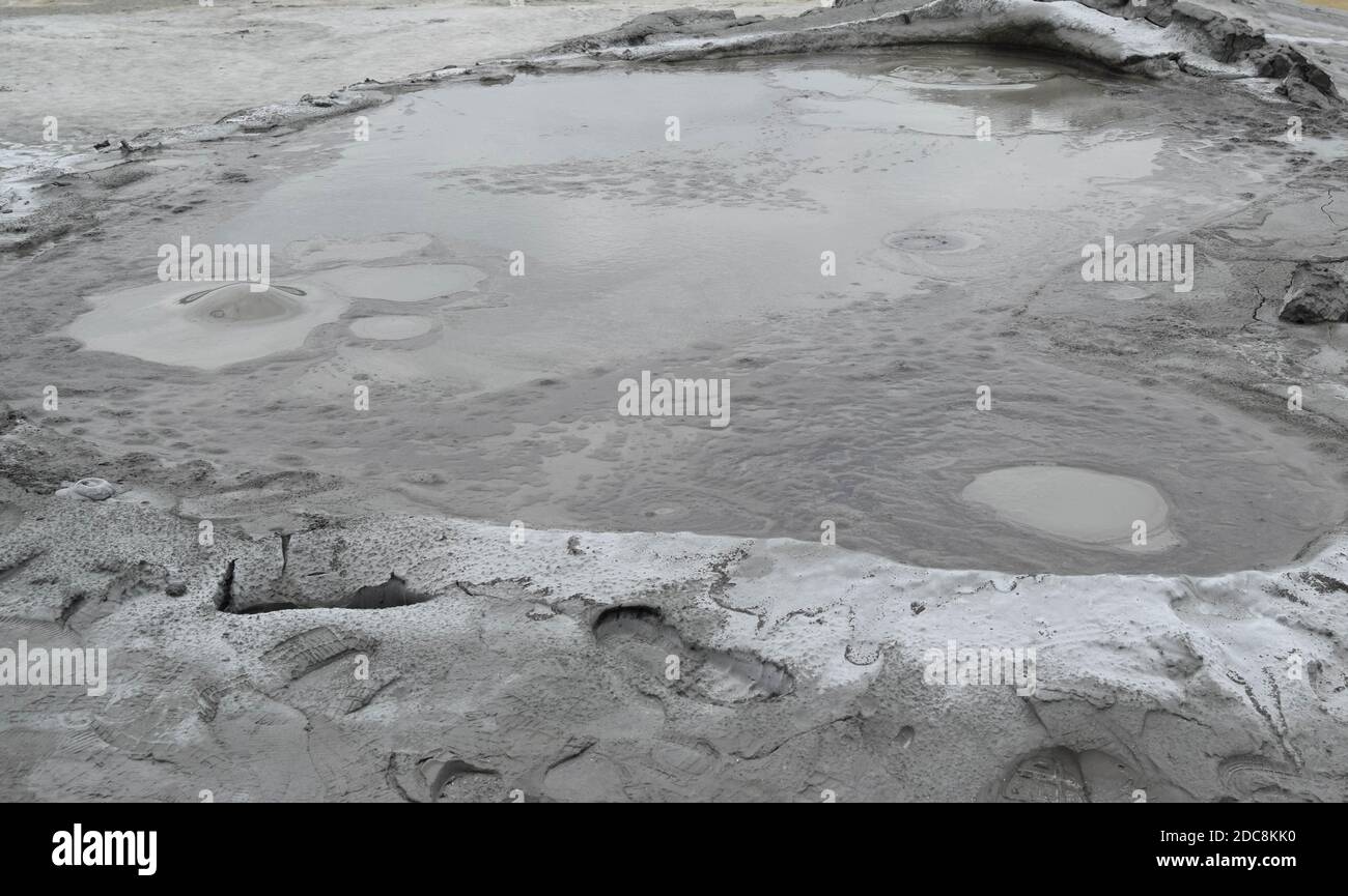 Bubbling crater of a mud volcano. Close up view onto gas bubble ...