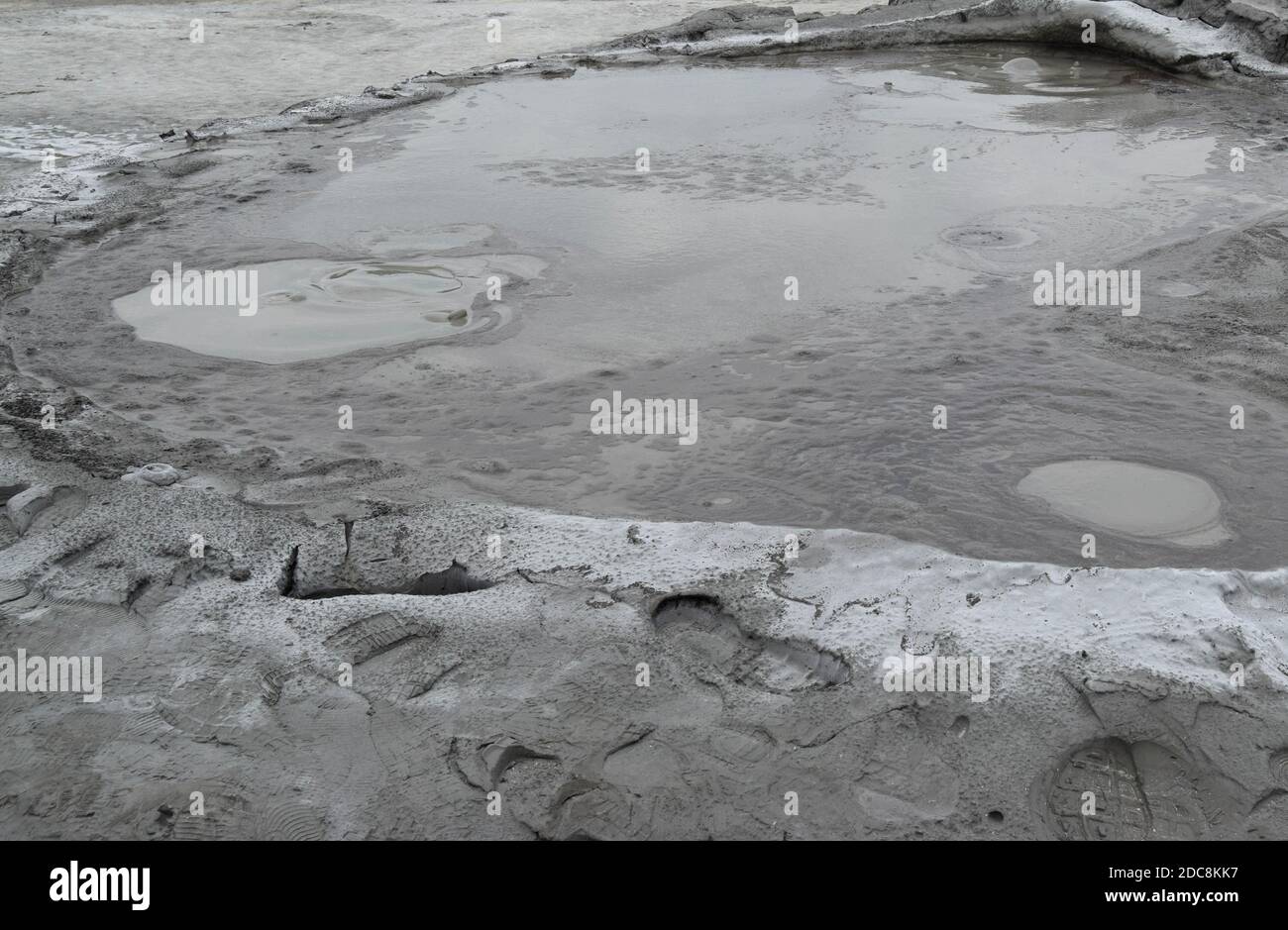 Bubbling crater of a mud volcano. Close up view onto gas bubble ...