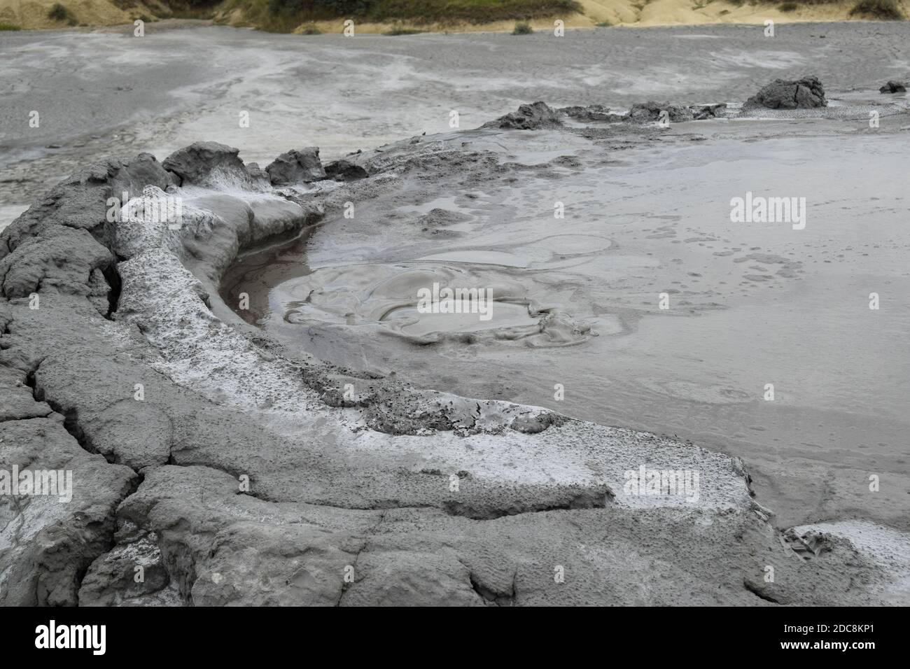 Bubbling crater of a mud volcano. Close up view onto gas bubble ...