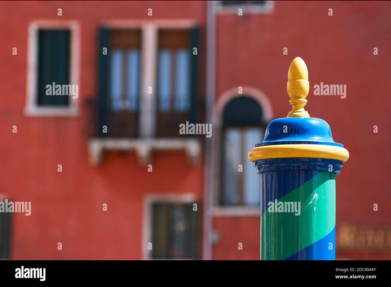 Typical colored striped poles for mooring boats in Venice. Italy Stock ...