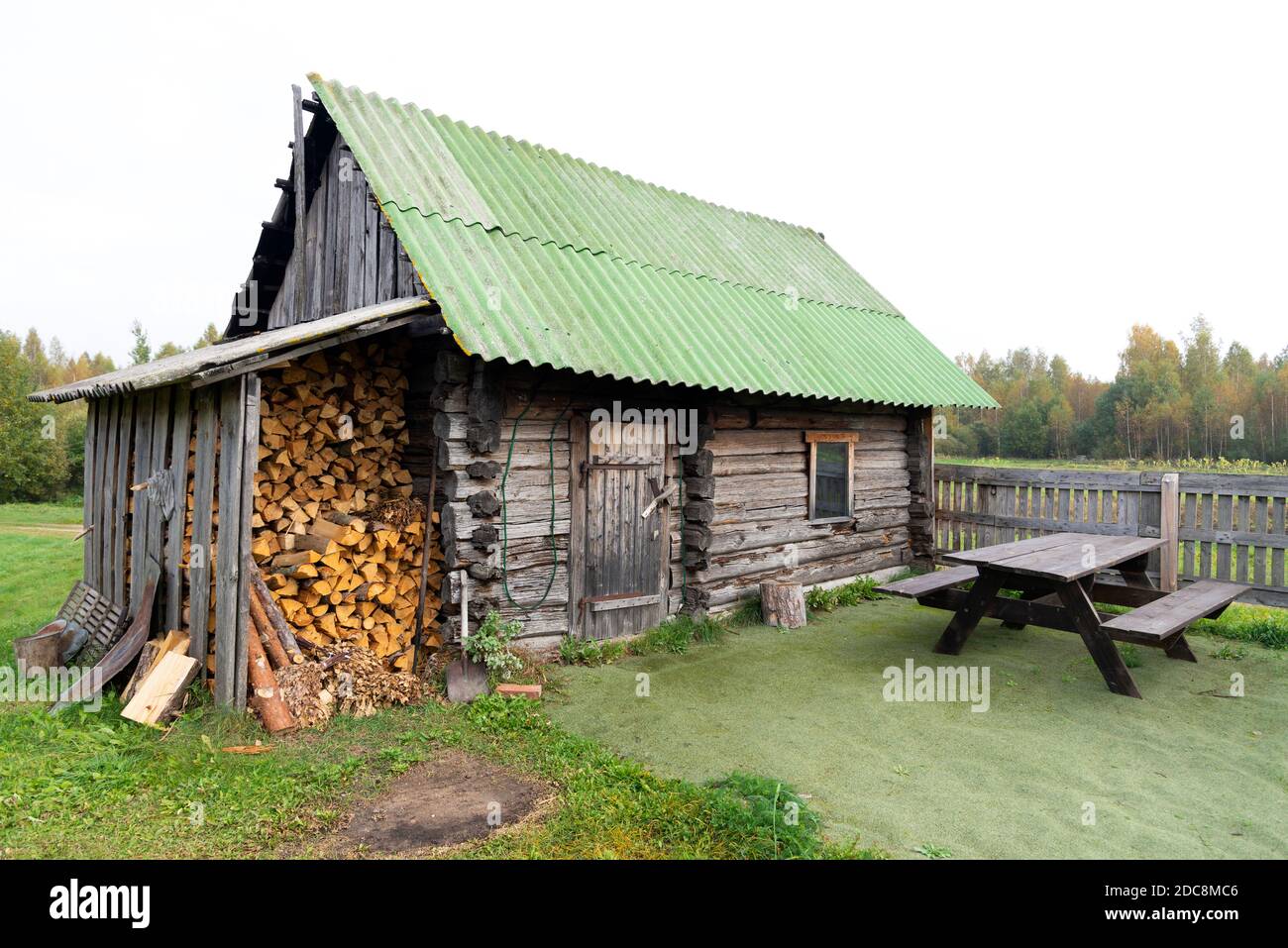 Old wooden house. Place for laying wood for kindling the stove near the ...