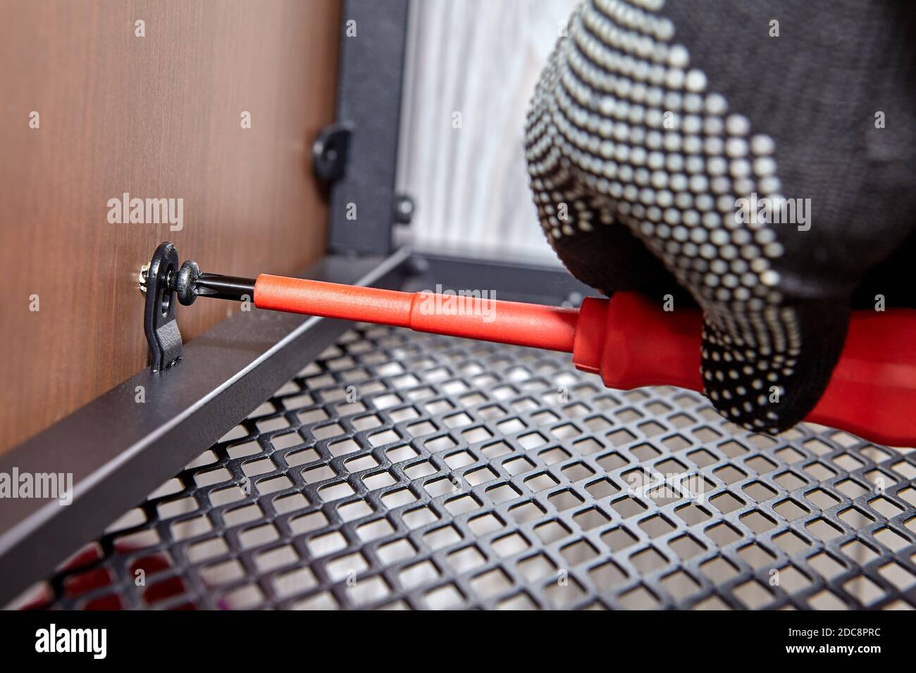 Mounting Of Metal Flat Pack Furniture By Handyman Worker Is Assembling