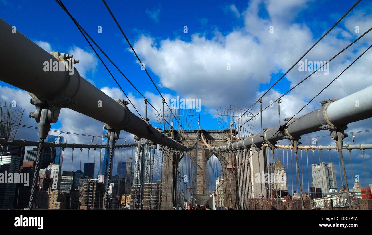 walking the Brooklyn Bridge under blue sky and clouds Stock Photo - Alamy