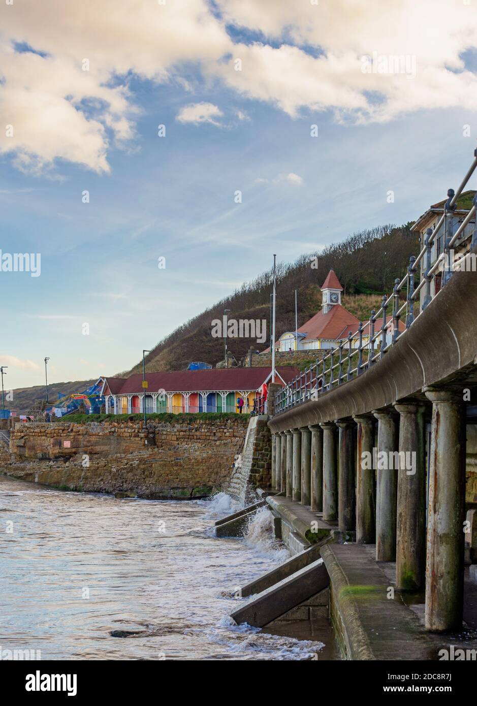 A promenade passes over the top of shelter lined with columns ...