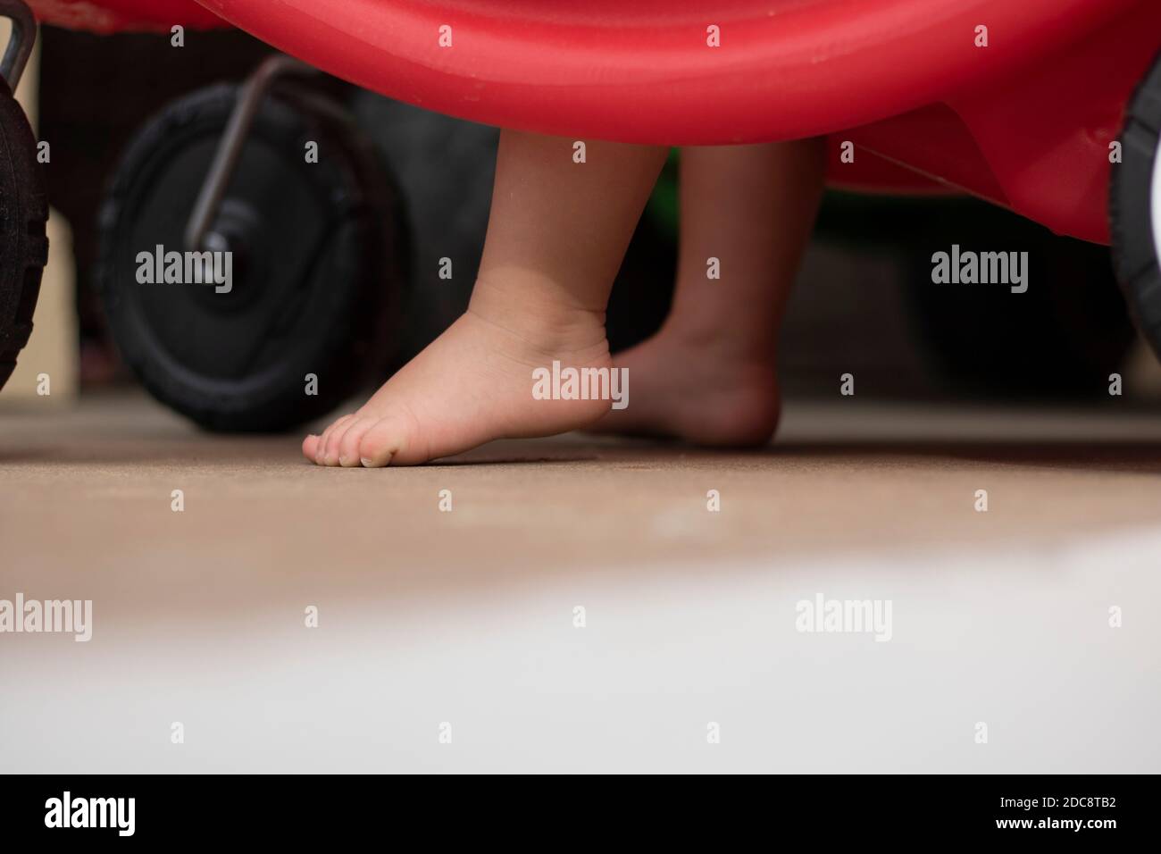 Child stepping out of a toy Stock Photo - Alamy