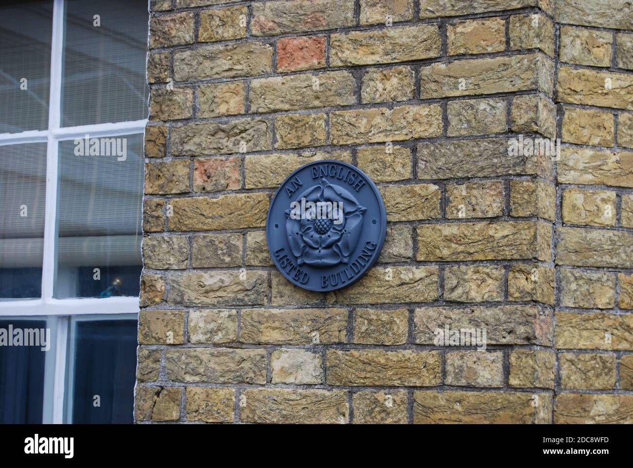 A cast lead plaque denoted a Listed Building in England Stock Photo - Alamy
