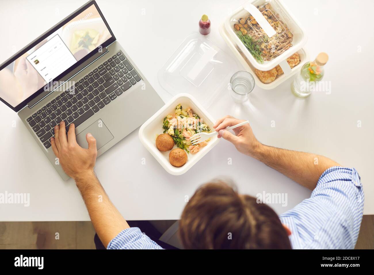 Man eating and working with laptop hi-res stock photography and images ...