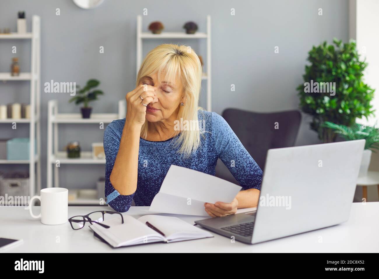 Tired senior woman receiving bankruptcy notification or rejection ...