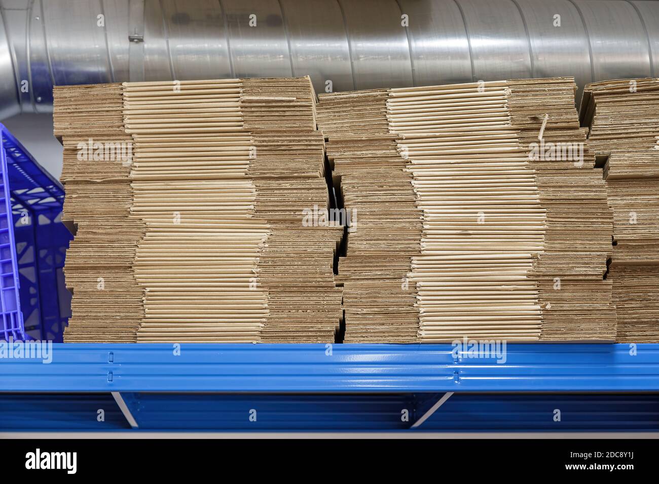 New folded cardboard boxes on a shelf, ready for packaging goods and ...