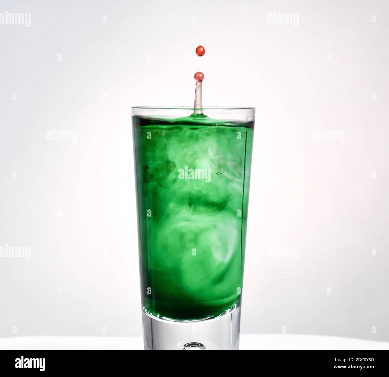 Colorful drop of dye floating in clear water glass Stock Photo - Alamy