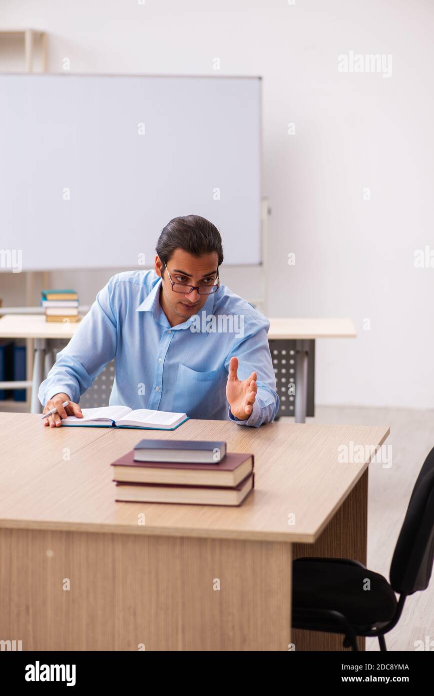 Young teacher in the classroom Stock Photo - Alamy