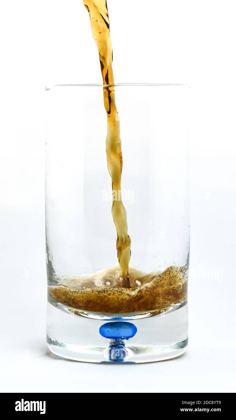 Pouring soda pop into clear glass Stock Photo - Alamy