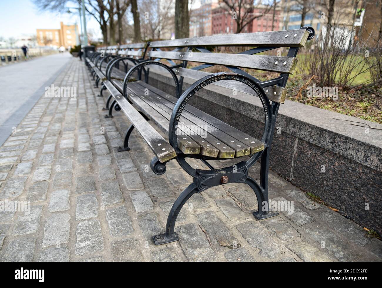 Empty park bench in the city Stock Photo - Alamy