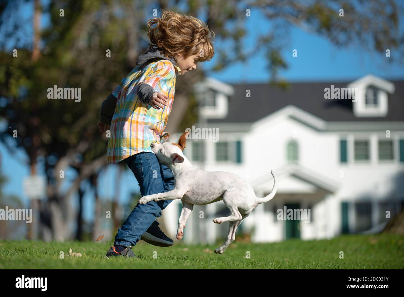 Funny photo of happy child playing with puppy dog Stock Photo - Alamy