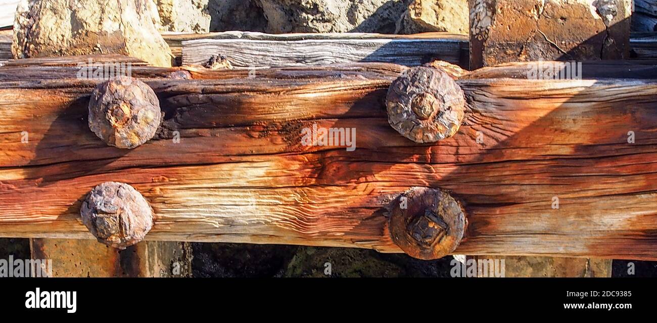 Rusty spikes nailed into weathered old timber dock and pier Stock Photo ...