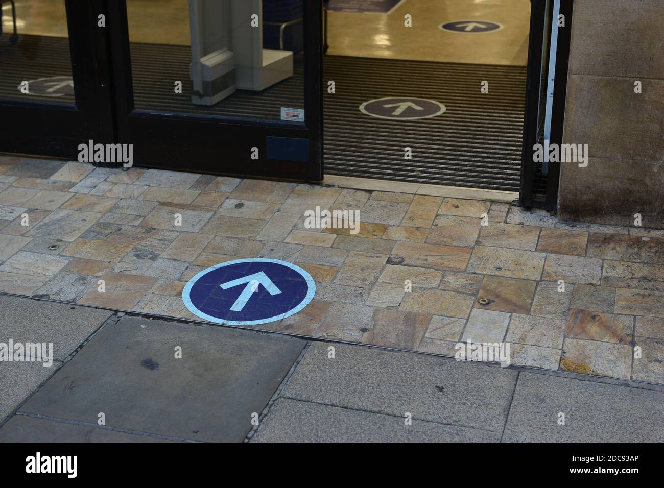 Cambridge Uk, , round arrows on floor, guiding people to walk in the ...