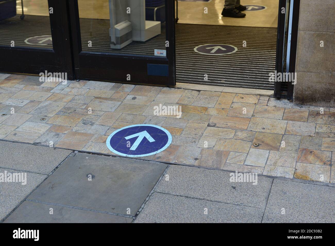 Cambridge Uk, , round arrows on floor, guiding people to walk in the ...