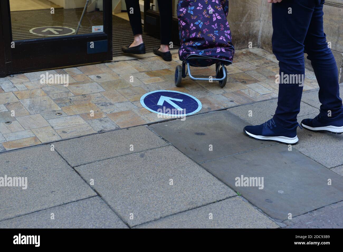 Cambridge Uk, , round arrows on floor, guiding people to walk in the ...