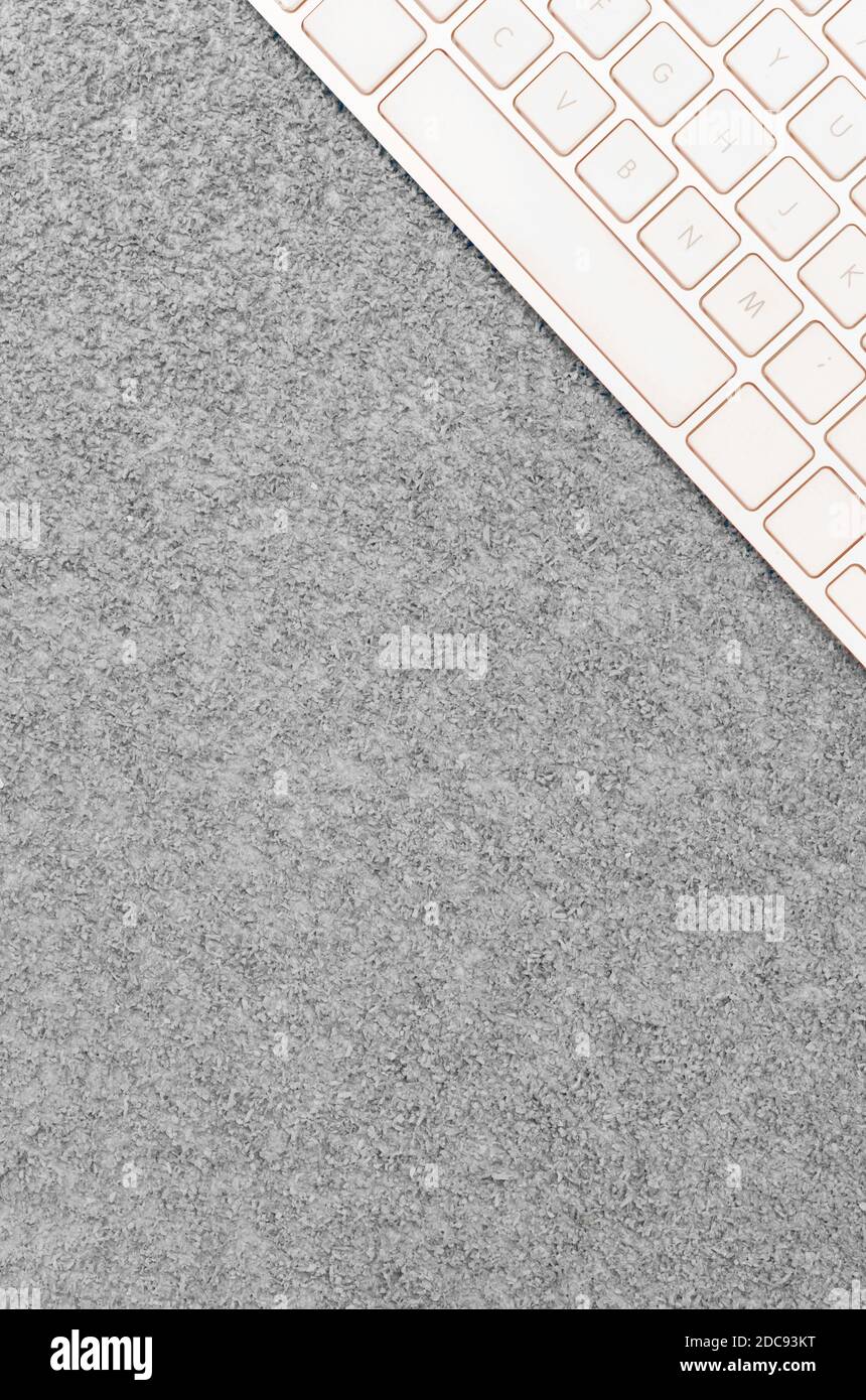 A vertical top view of a computer keyboard on an office desk with copy ...