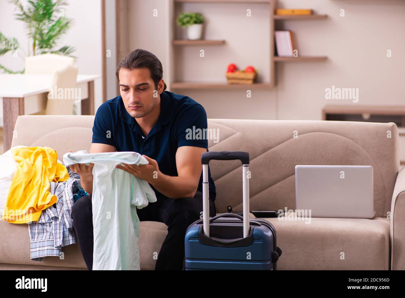 Young man preparing for trip at home Stock Photo - Alamy