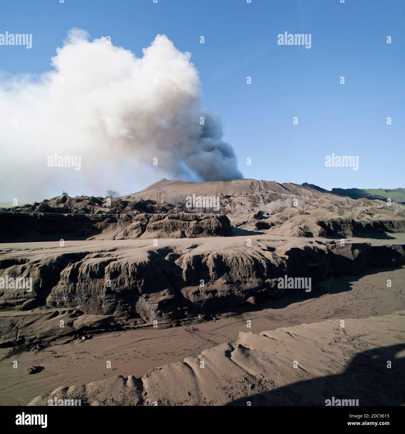 Mount Bromo volcano erupting sending ash clouds high into the sky, East ...
