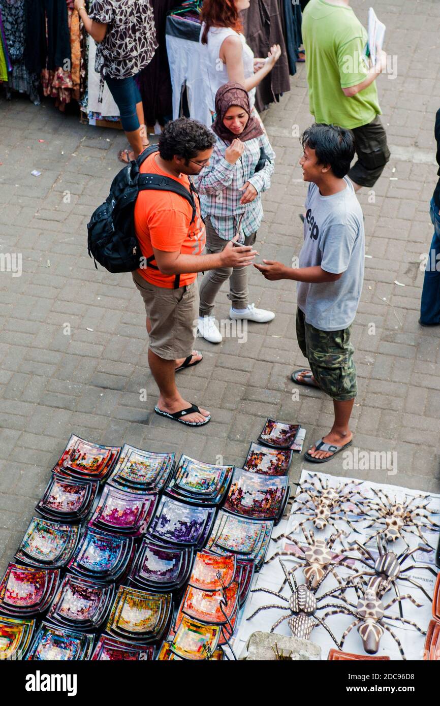 Tourist Bartering at a market stall in Ubud Market, Bali, Indonesia ...