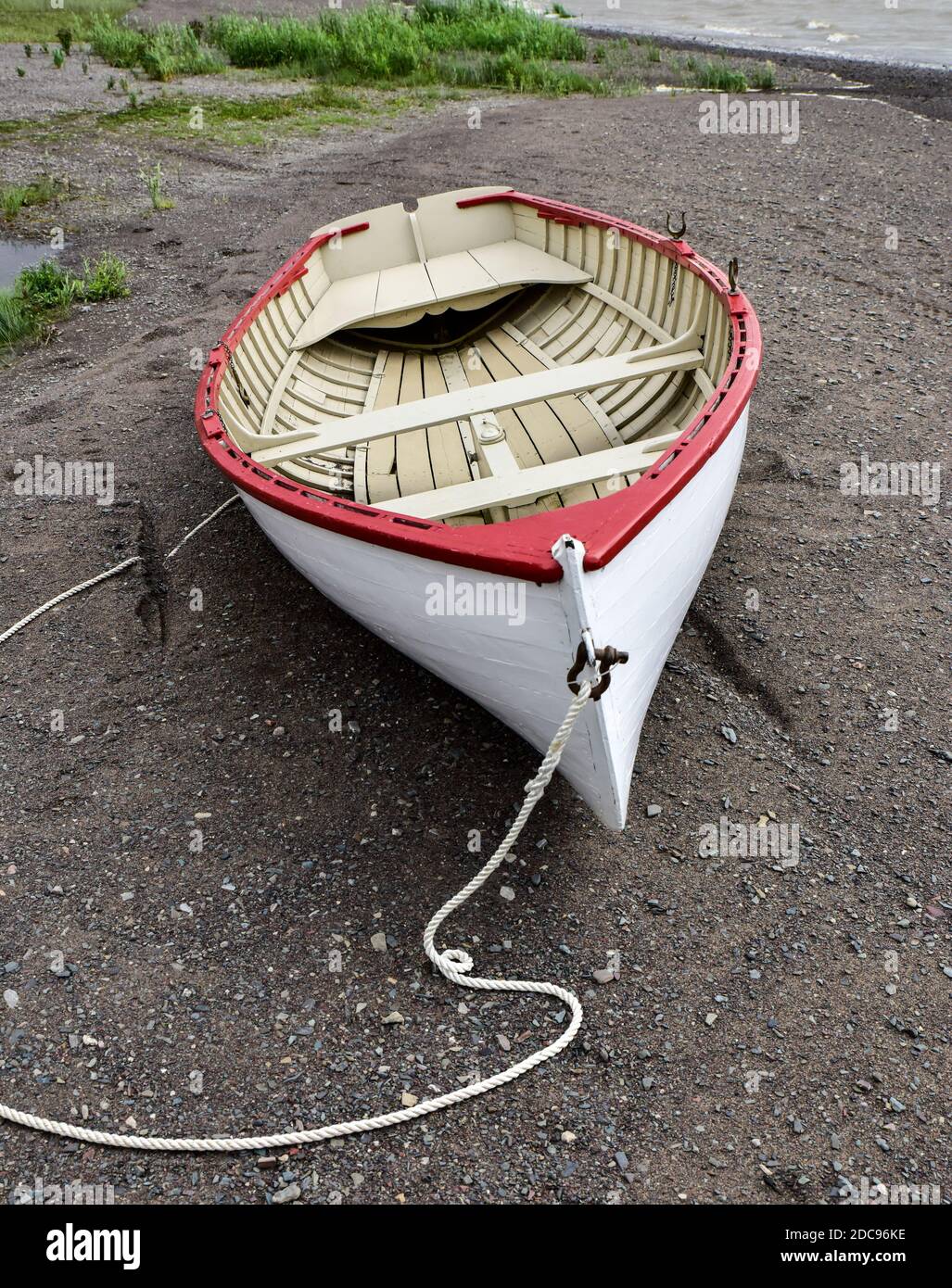 old vintage wooden rowboat beached along the sandy ocean shore Stock ...