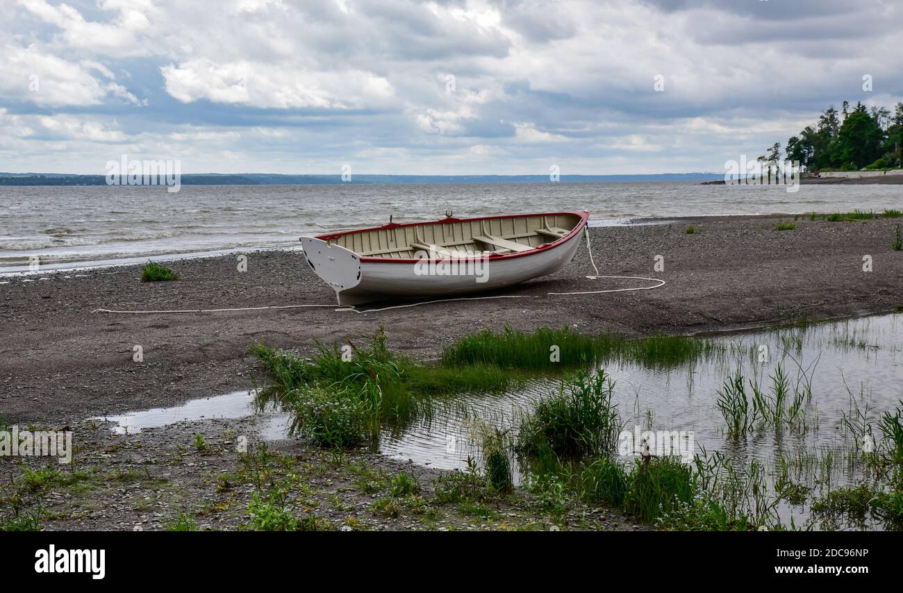 old vintage wooden rowboat beached along the sandy ocean shore Stock ...