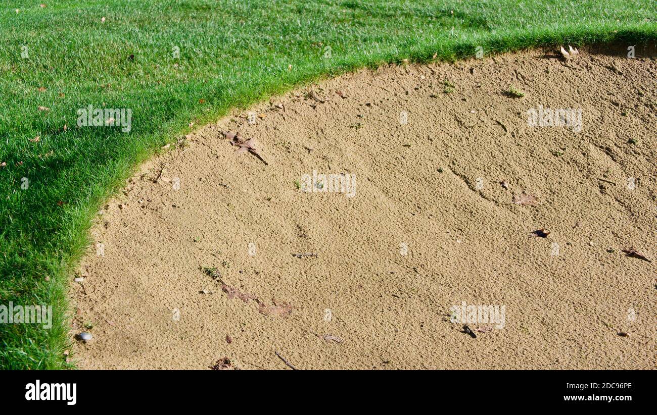 Golf bunker showing grass and sand with space for copy Stock Photo - Alamy