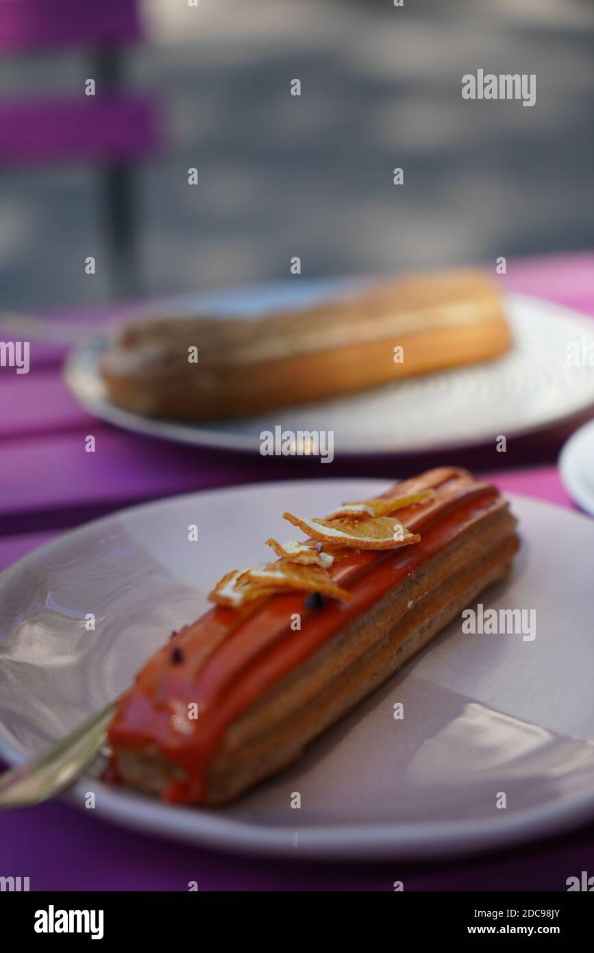 Eclair Plate in Cafe on the Table A Sunny Day Stock Photo - Alamy