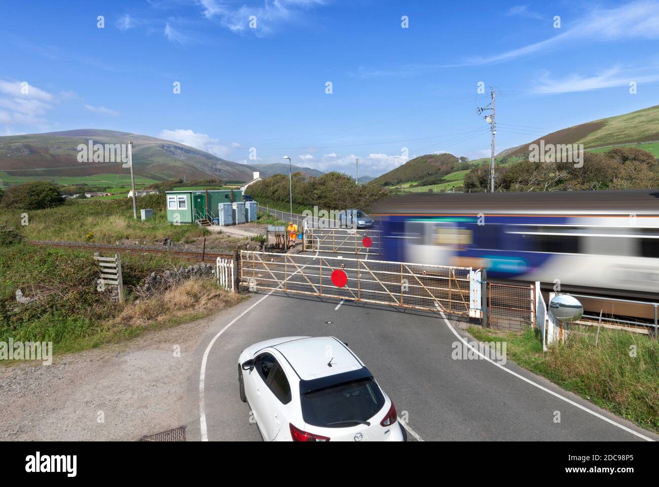 Northern rail train crossing the manual gated level crossing at ...