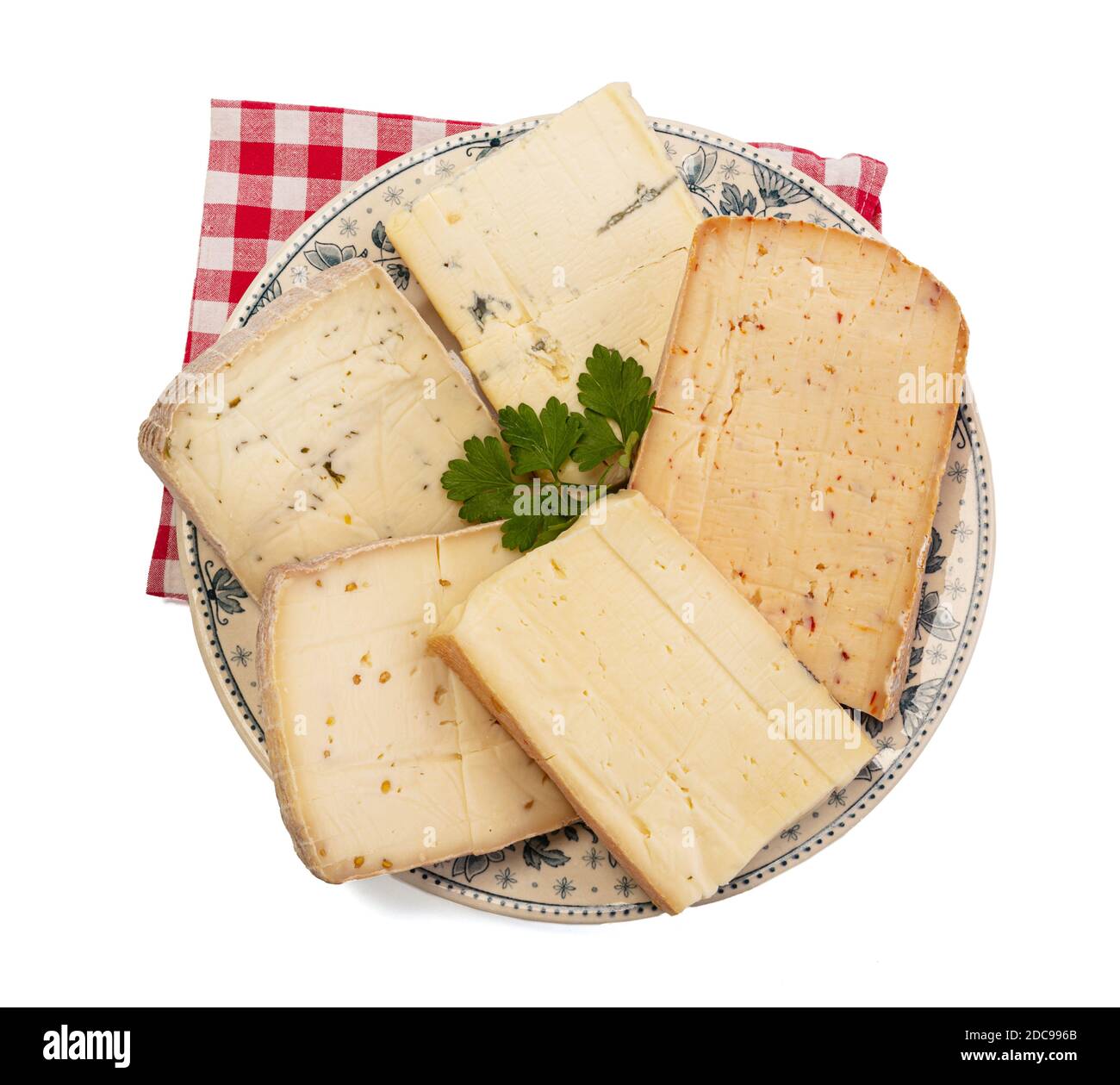 Raclette cheese platter with several flavors on white background Stock ...