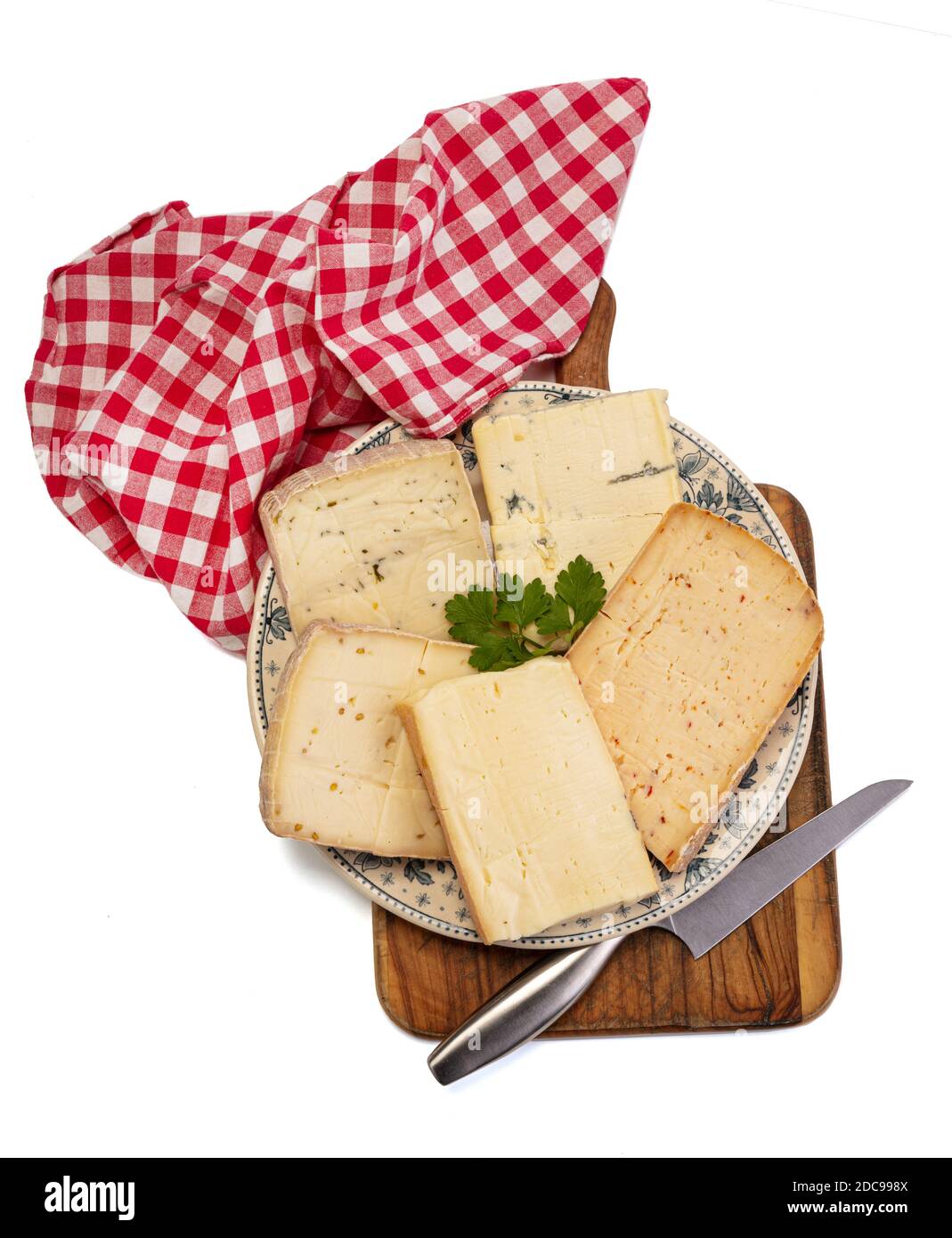 Raclette cheese platter with several flavors on white background Stock ...