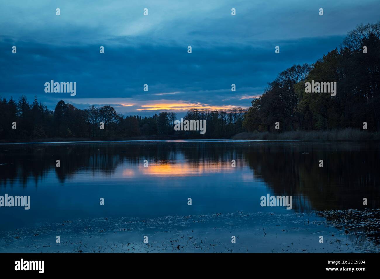 sunset over a rural lake Stock Photo - Alamy