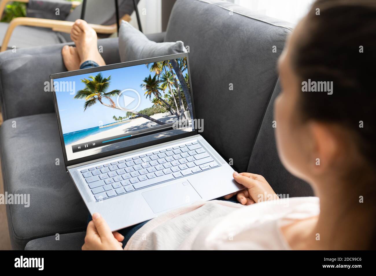 Watching TV Video On Laptop At Sofa Or Couch Stock Photo - Alamy