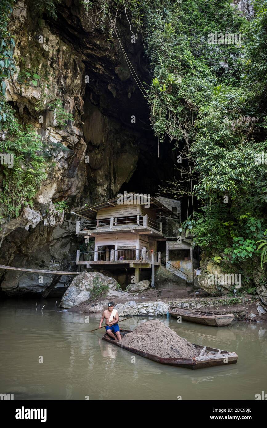 Sand miner emerging from Sungai Angek Cave near Bukittinggi, West ...