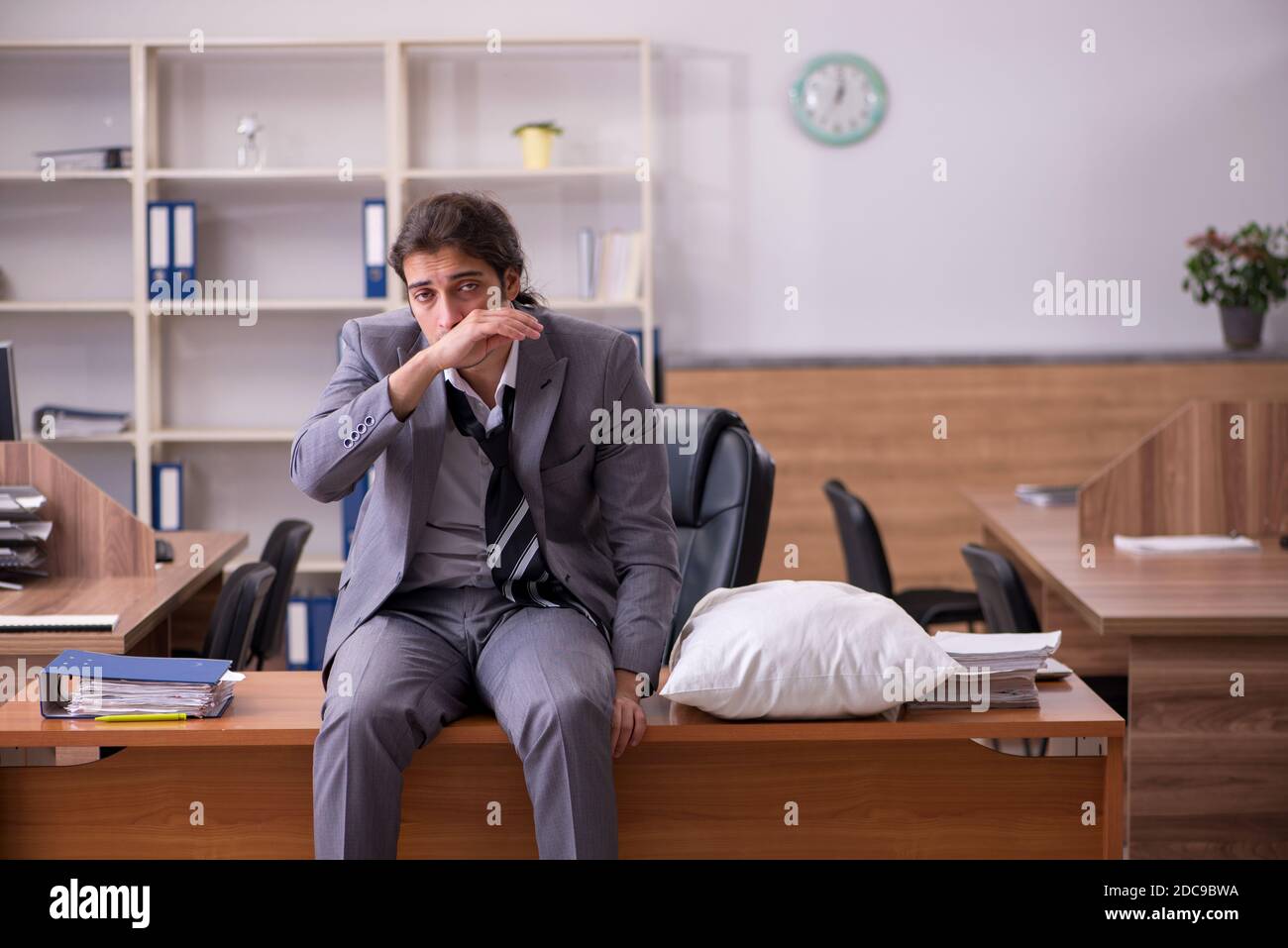 Young employee sleeping at workplace Stock Photo - Alamy
