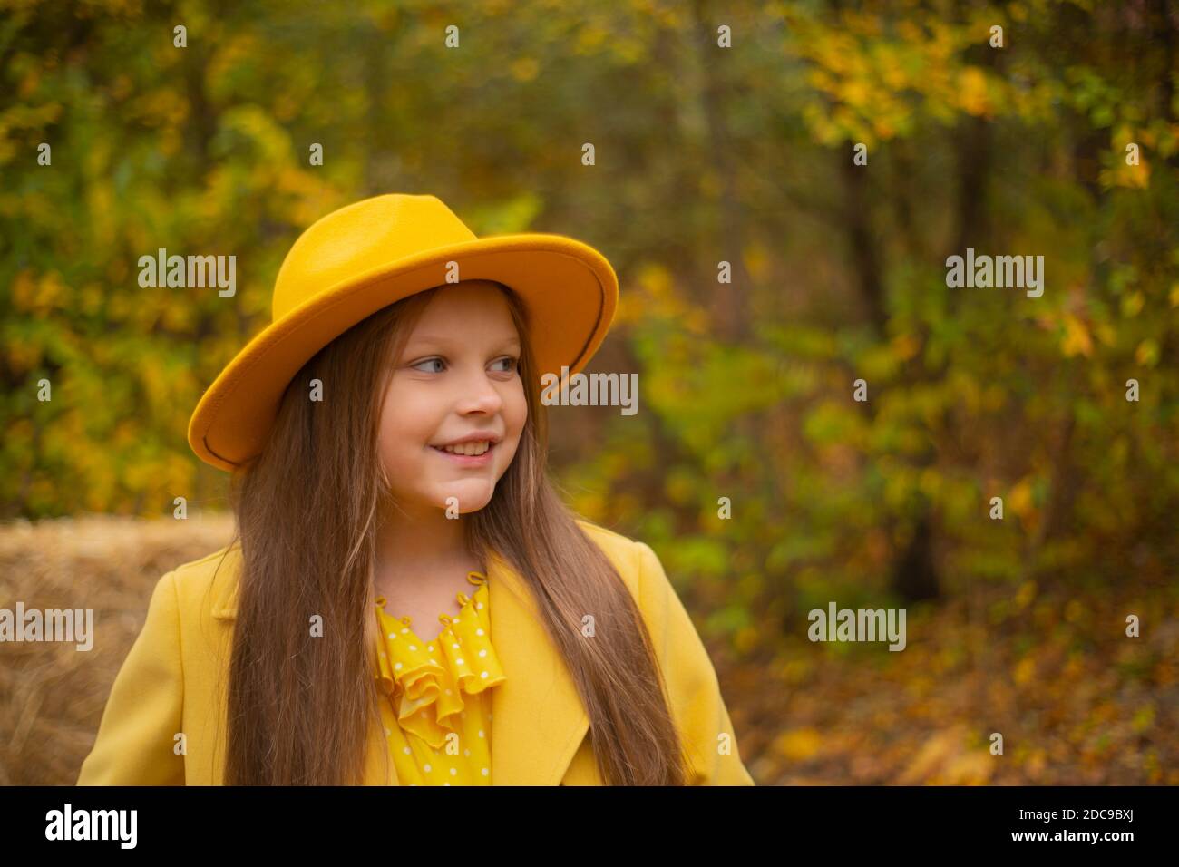 portrait of cute beautiful teenage brunette girl in an orange hat ...