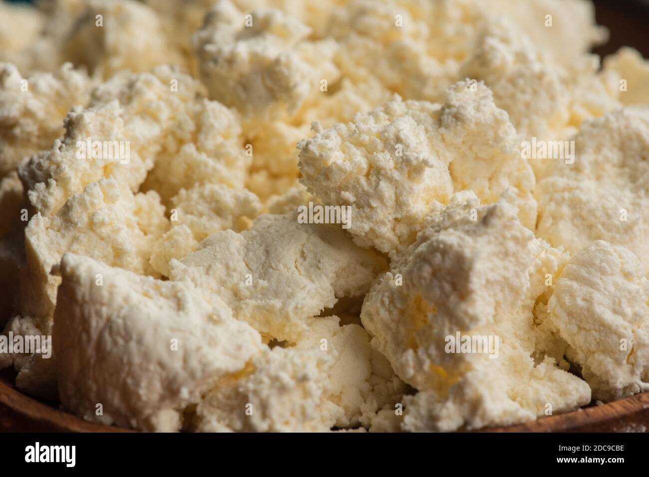 cottage cheese in rustic wooden plate. Cottage cheese in a wooden plate ...
