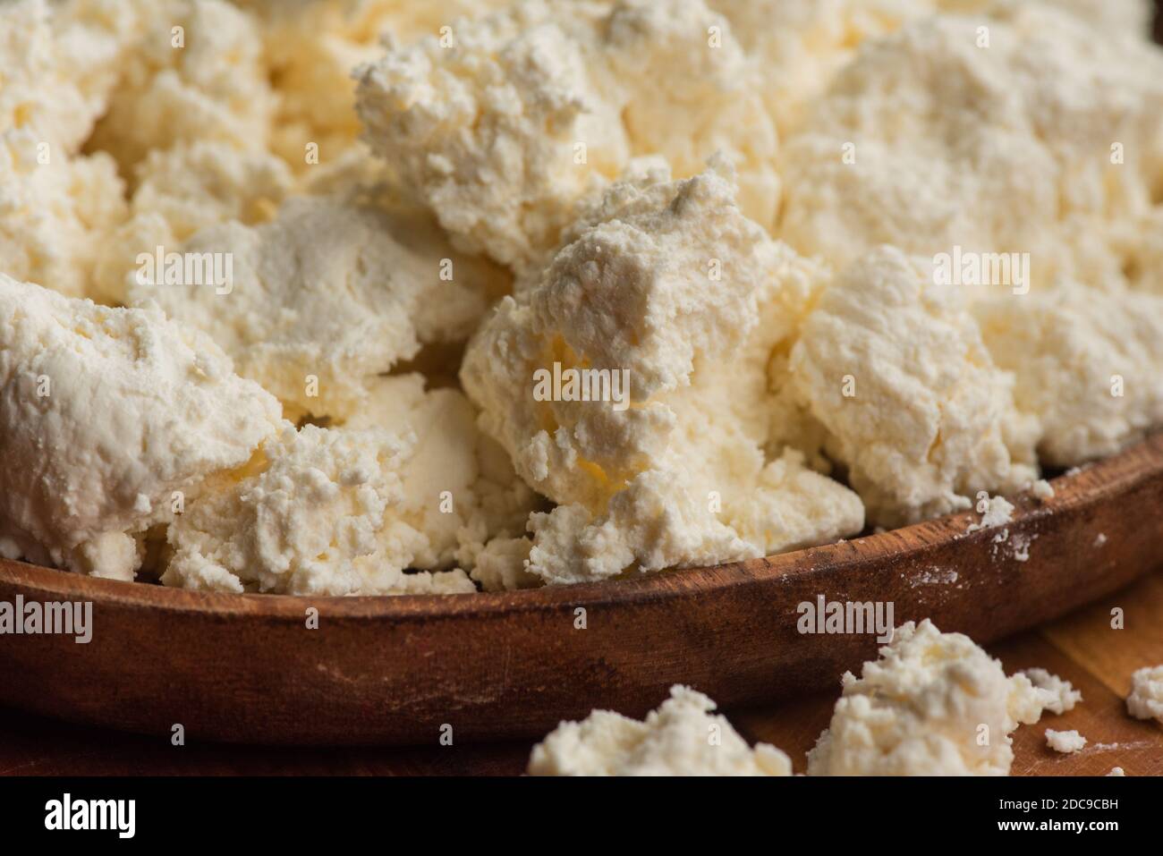 cottage cheese in rustic wooden plate. Cottage cheese in a wooden plate ...