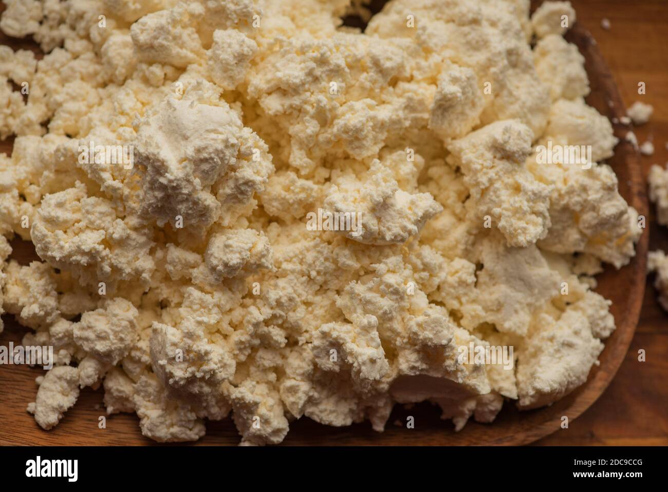 cottage cheese in rustic wooden plate. Cottage cheese in a wooden plate ...