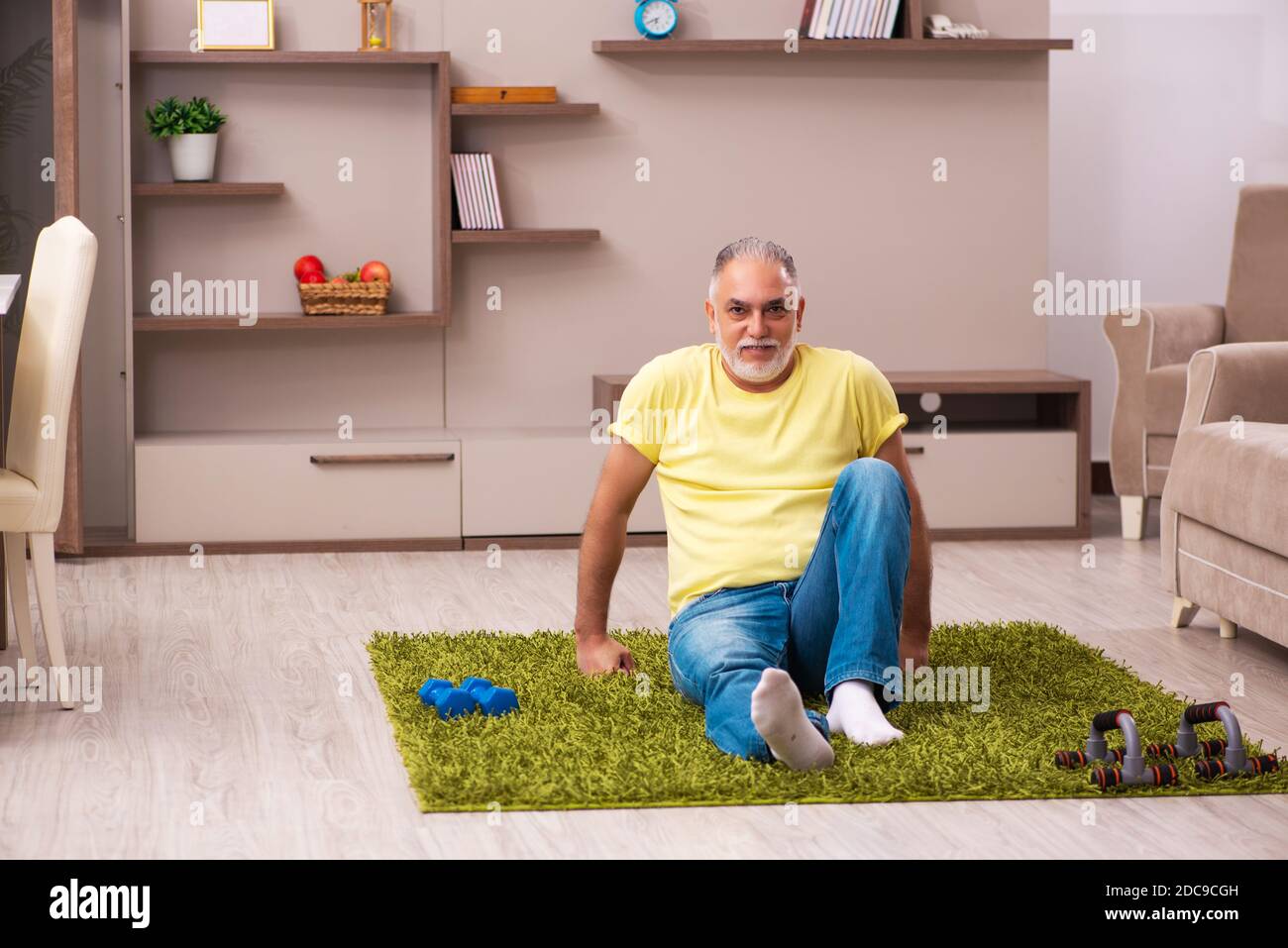 Old man doing sport exercises at home Stock Photo - Alamy