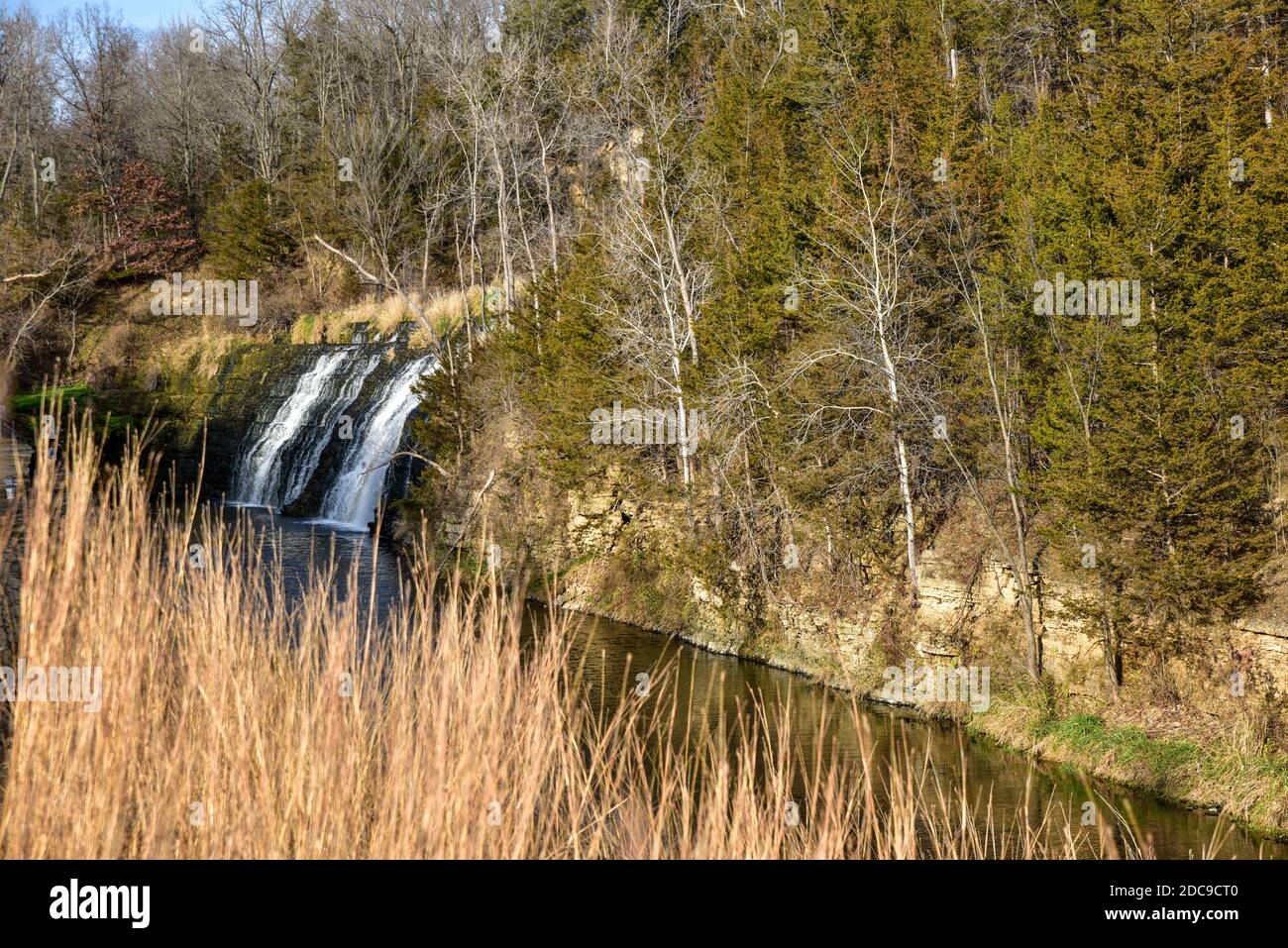 flowing water over water fall splashing on rocks Stock Photo - Alamy
