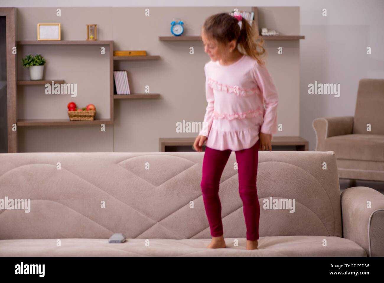 Little girl staying alone at home Stock Photo - Alamy